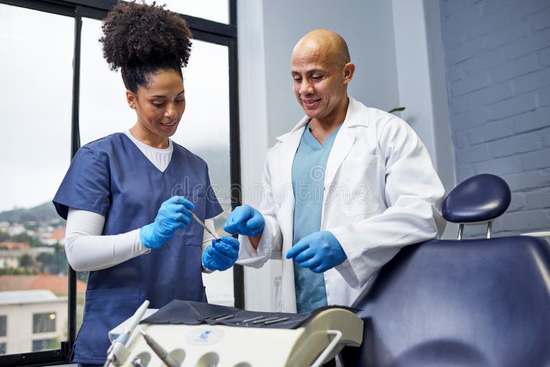 Smiling Dental Professionals Collaborating in a Bright Office Examining ...