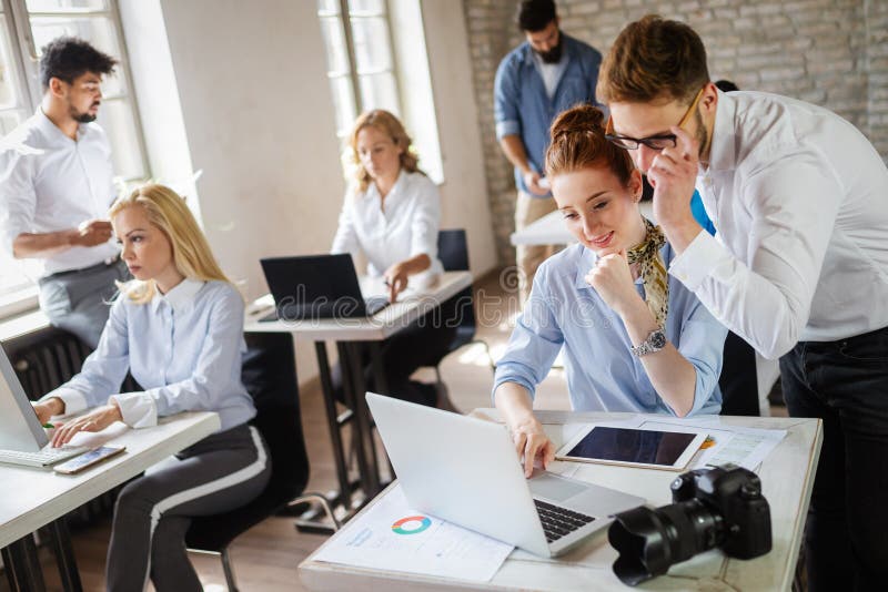 Happy Designer People Working Together at Desk on Computer in Office ...