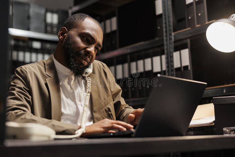 Smiling Detective Talking on Phone and Using Laptop Stock Photo - Image ...