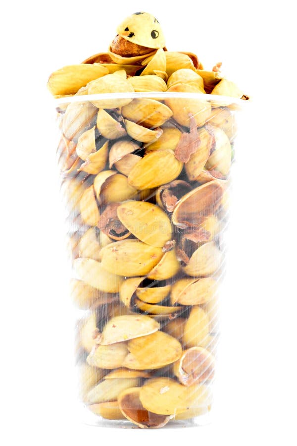 Smiling Dinosaur Pistachio in Plastic Cup with Heap of Nutshells Stock ...