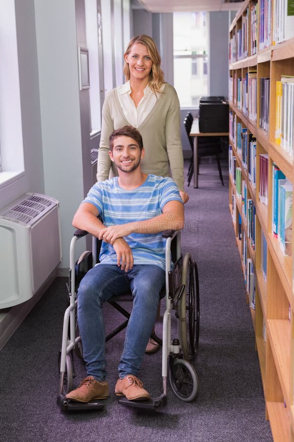 Smiling Disabled Student with Classmate in Library Stock Photo - Image ...