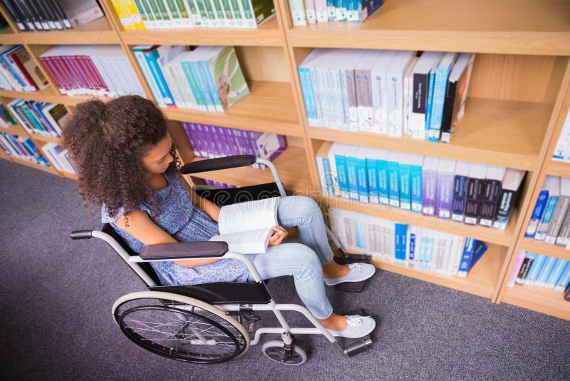 Smiling Disabled Student in Library Reading Book Stock Photo - Image of ...