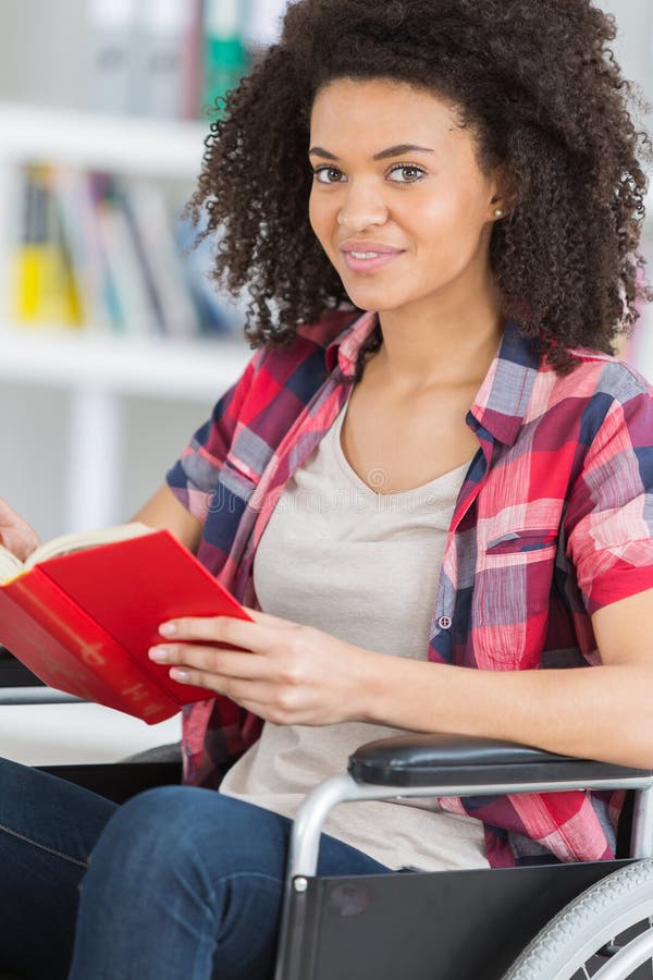 Smiling Disabled Student in Library Reading Book at University Stock ...