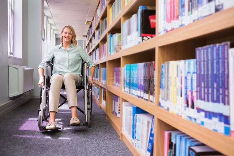 Man and Disabled Student in Wheelchair Reading Books in Library Stock ...