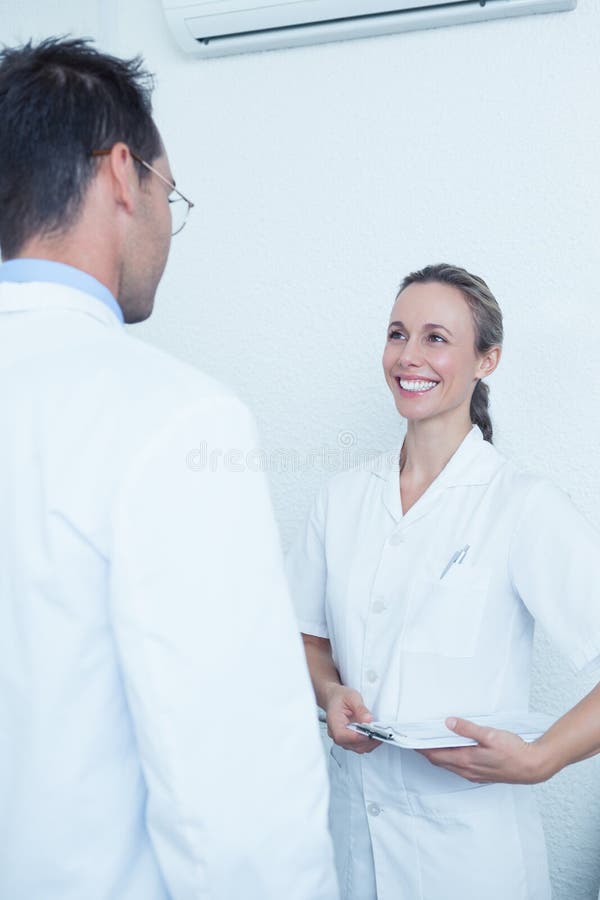 Smiling discussing reports stock photo. Image of adult - 49036126