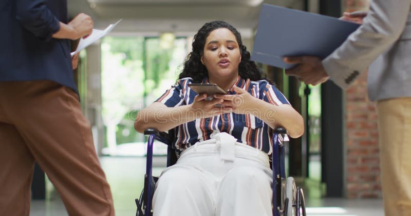 Smiling Diverse Business People With Colleague In Wheelchair Talking In