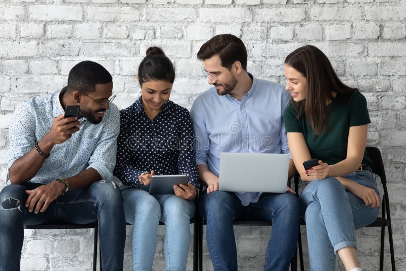 Smiling Diverse Candidates Prepare for Interview Using Gadgets Stock ...