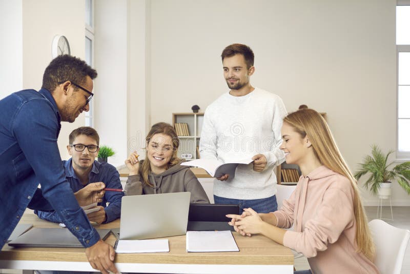 Smiling Multiracial Young People Work Together on Computer Stock Image ...