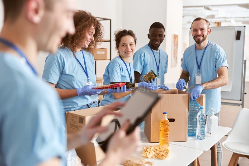 Smiling Volunteers Sorting Donation Boxes Stock Photos - Free & Royalty ...