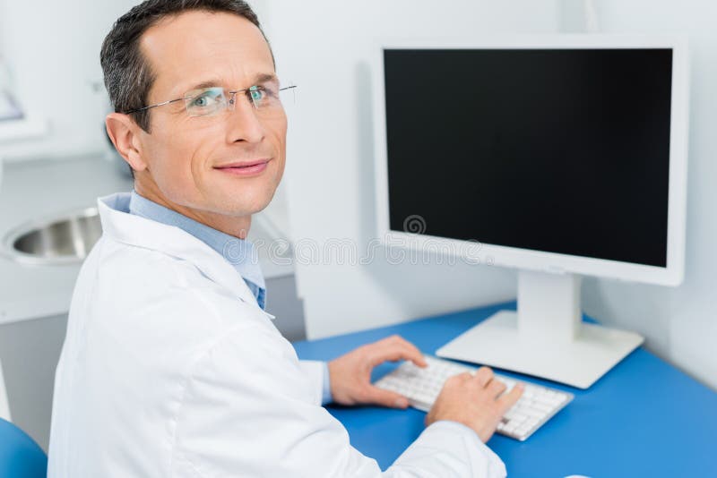 Smiling Doctor in Glasses Working by Computer Stock Photo - Image of ...