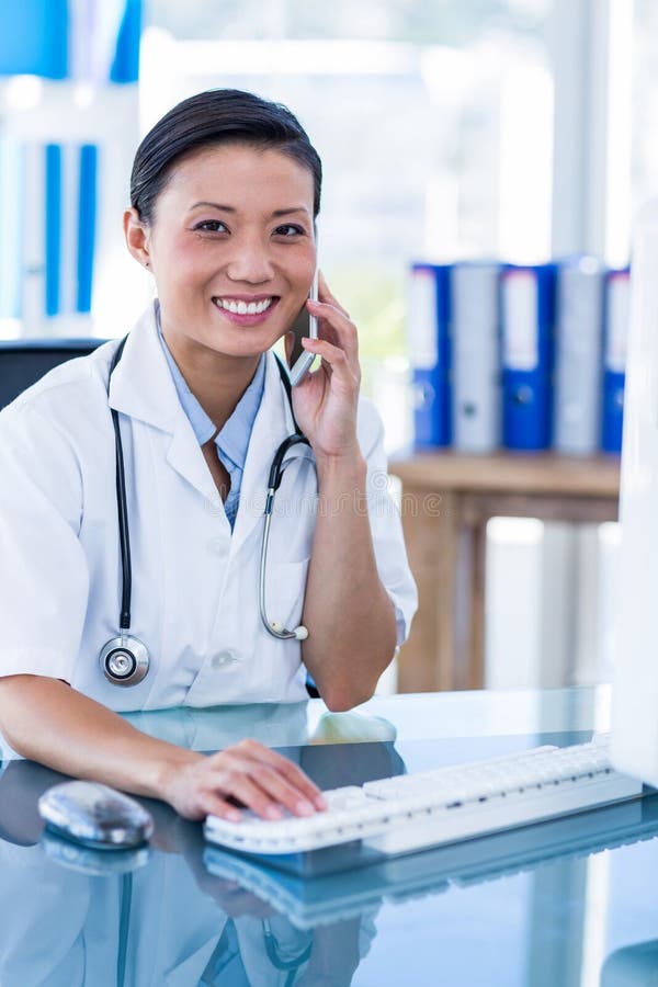 Smiling Doctor Looking at Camera and Having Phone Call Stock Photo ...