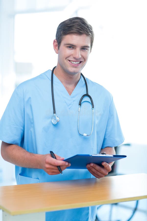 Smiling Doctor Looking at Camera and Holding Clipboard Stock Image ...