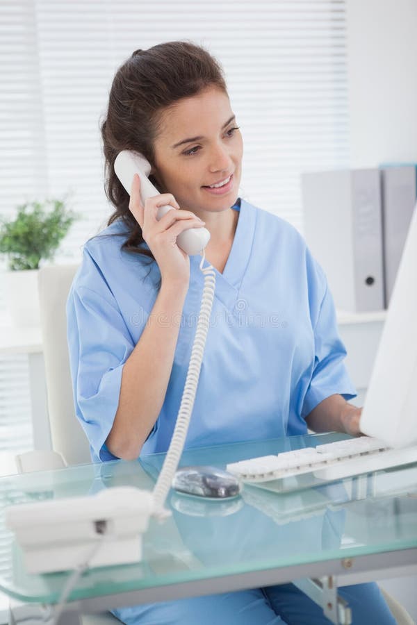 Smiling Doctor Phoning and Using Computer Stock Image - Image of long ...
