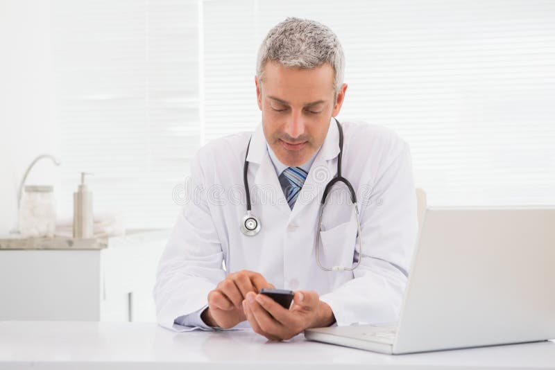 Smiling Doctor Using His Phone Stock Image - Image of touching ...
