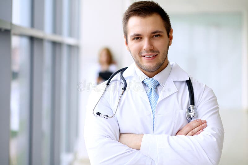 Smiling Doctor Waiting for His Team while Standing Upright Stock Photo ...