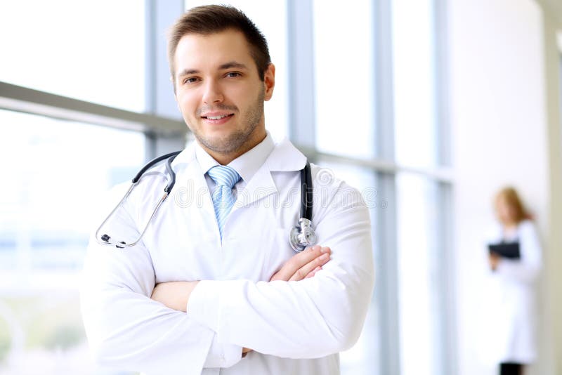 Smiling Doctor Waiting for His Team while Standing Upright Stock Photo ...