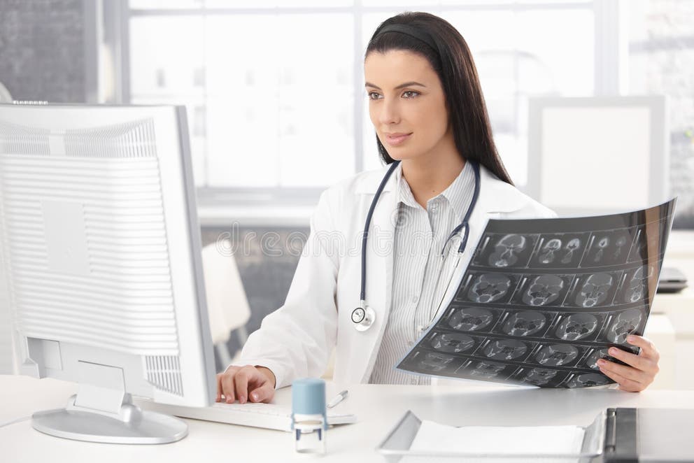 Smiling Doctor Working at Desk Stock Image - Image of doctors, health ...