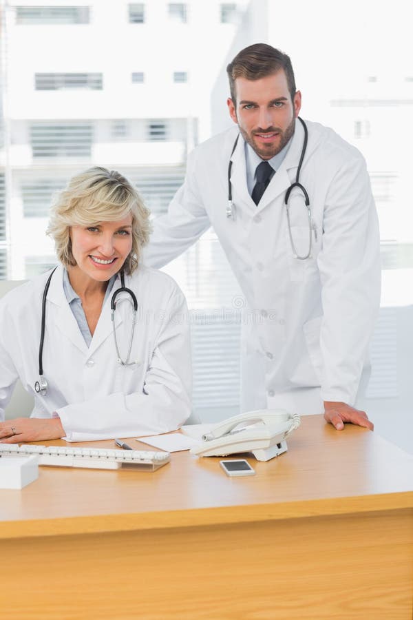 Smiling Doctors with Computer at Medical Office Stock Photo - Image of ...