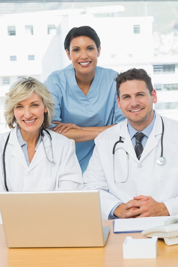 Smiling Doctors with Laptop at Medical Office Stock Image - Image of ...