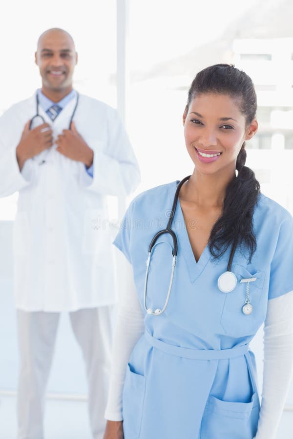 Smiling Doctors Looking at Camera Stock Photo - Image of coat, medicine ...