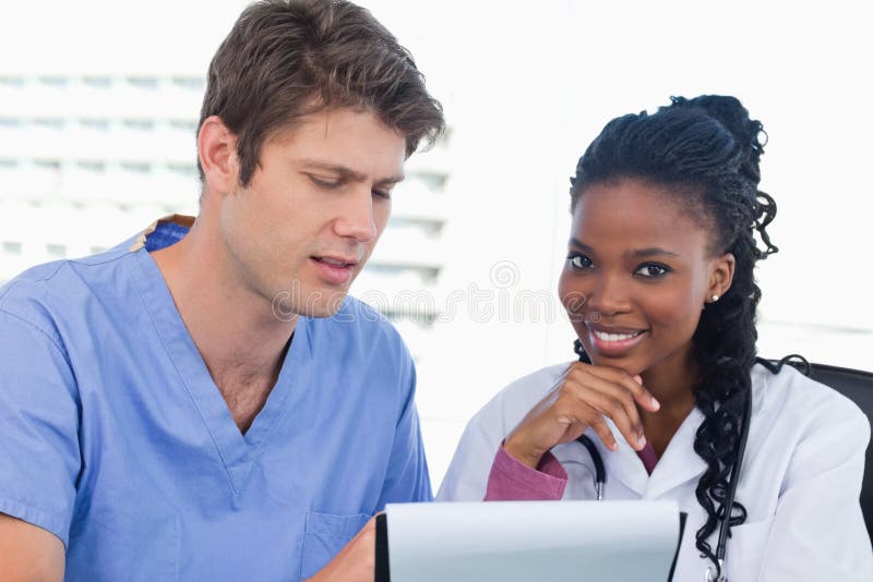 Smiling Doctors Looking at a Document Stock Image - Image of health ...