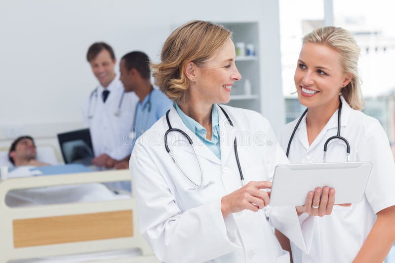 Smiling Doctors Talking To Each Other Stock Image - Image of female ...