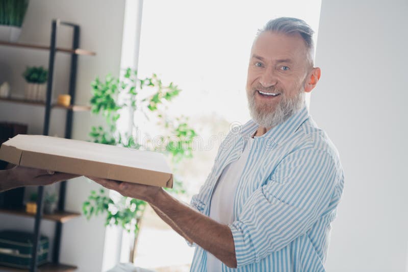 Smiling Elderly Man Enjoys Daytime Indoors while Receiving a Package in ...