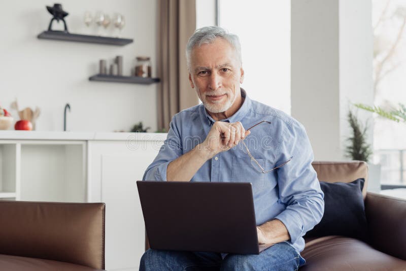 Smiling Elderly Man with Laptop Looking at Camera Stock Photo - Image ...