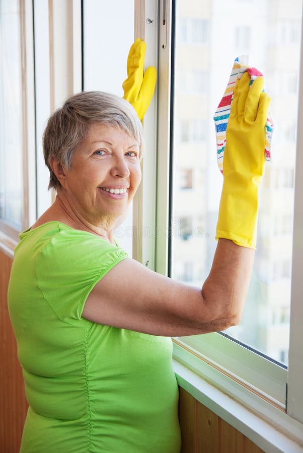 Smiling Elderly Woman Cleaning a Window Stock Photo - Image of motion ...