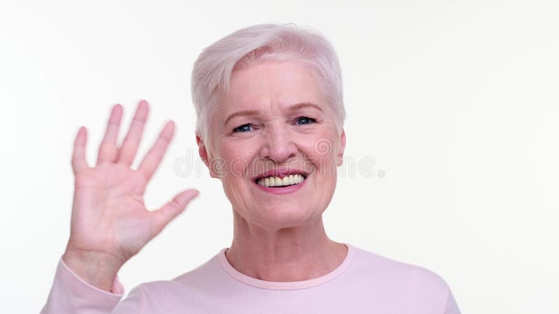 Smiling Elderly Woman Waving Hello on White Background Stock Video ...