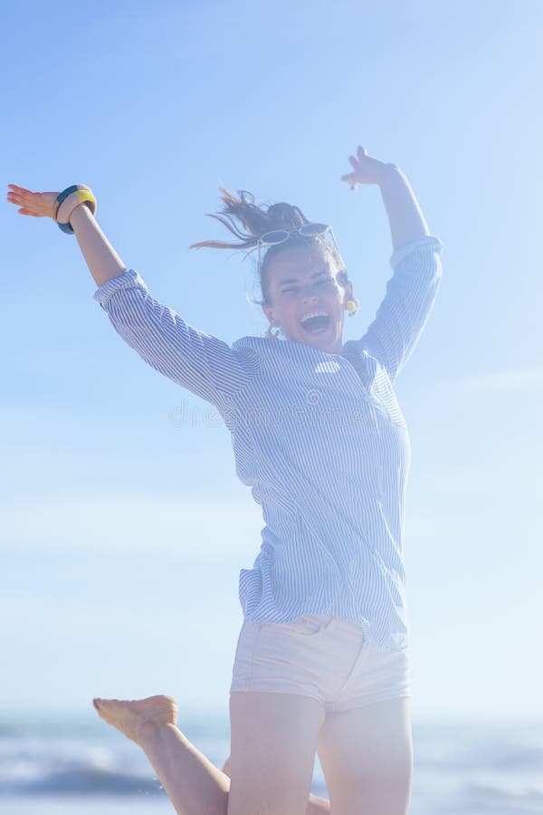 Smiling Elegant Woman at Beach Jumping Stock Photo - Image of nature ... Smiling Elegant Woman at Beach Jumping Stock Photo - Image of nature ...