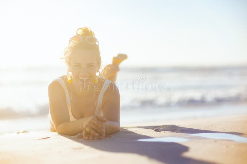 Smiling Elegant Woman in White Swimwear Laying at Beach Stock Image ... Smiling Elegant Woman in White Swimwear Laying at Beach Stock Image ...