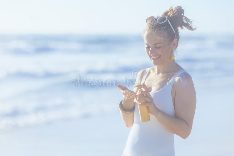 Smiling Elegant Woman in Swimwear at Beach Applying Spf Stock Image ... Smiling Elegant Woman in Swimwear at Beach Applying Spf Stock Image ...