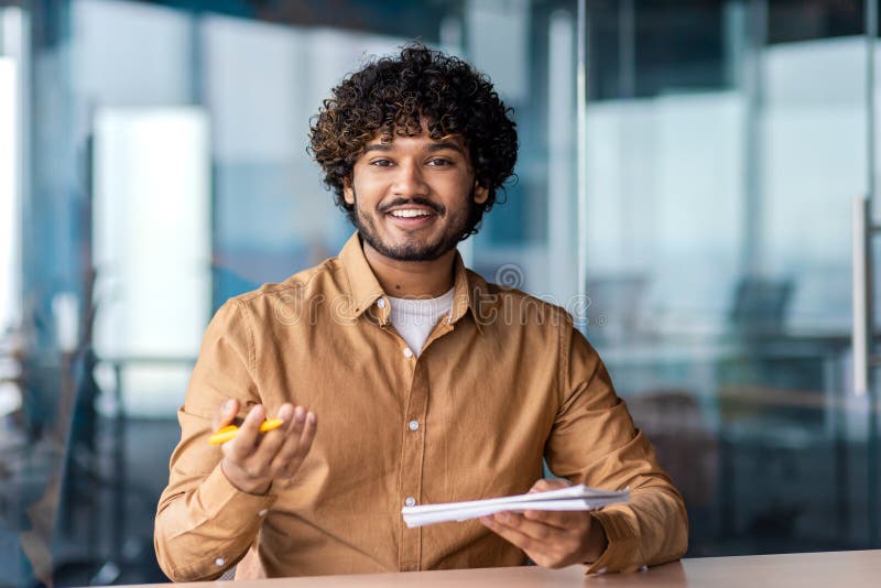 Smiling Employee Sitting in the Office Conducting a Video Call ...