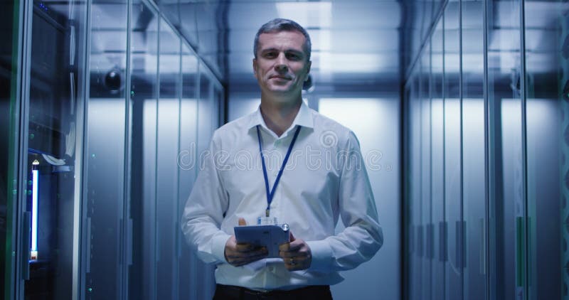 Smiling Engineer in Corridor of Data Center Stock Image - Image of ...