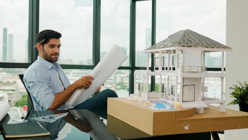 Smiling Engineer Looking Project Plan while Design House Model. Tracery Stock Photo - Image of ...