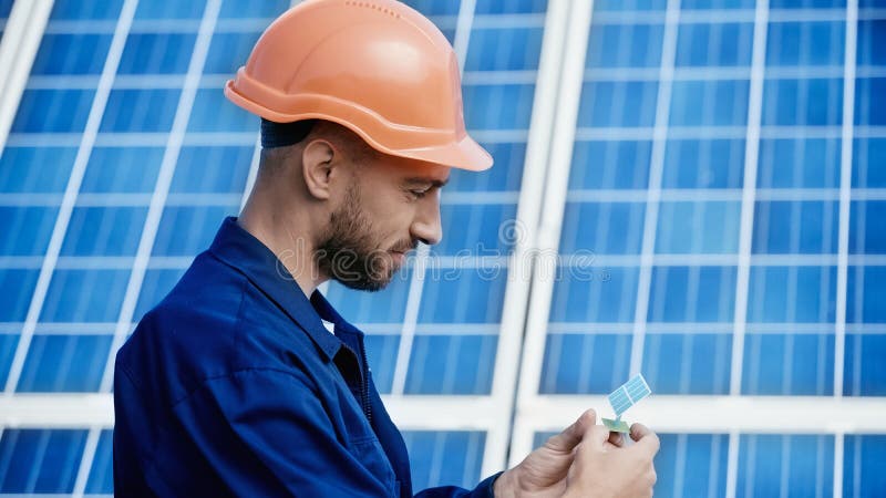 Smiling Engineer Looking at Small Model Stock Photo - Image of orange ...