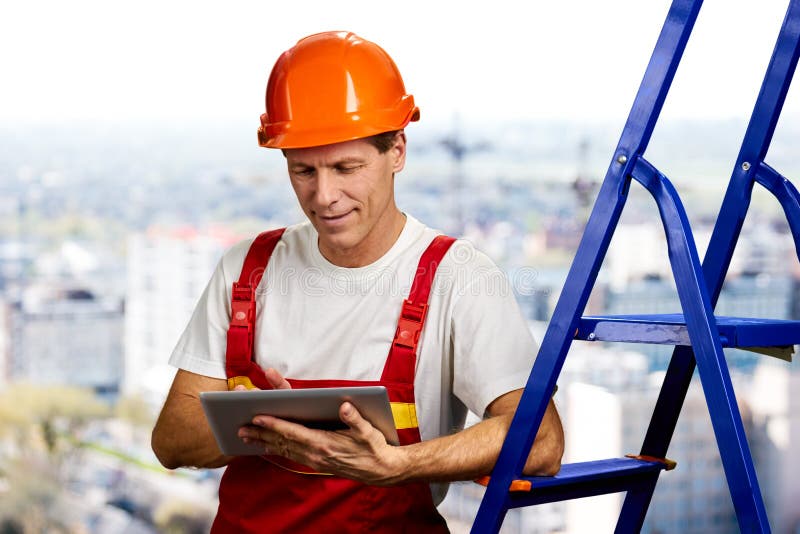 Smiling Engineer Using Digital Tablet. Stock Photo - Image of ladder ...