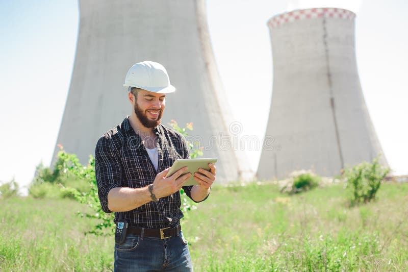 Smiling Engineer Using a Tablet in a Facility. Stock Image - Image of ...