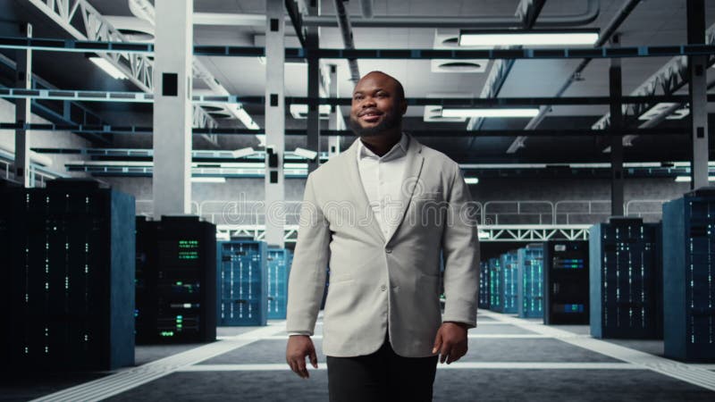 Smiling Engineer Walking in Data Center, Checking Hardware for System ...