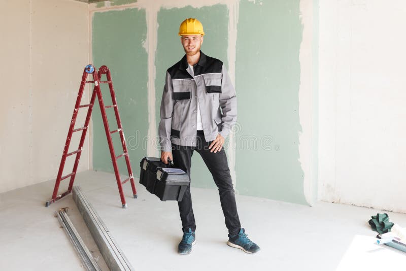 Two Builders in Work Clothes and Hardhats Working in Workshop Wi Stock ...