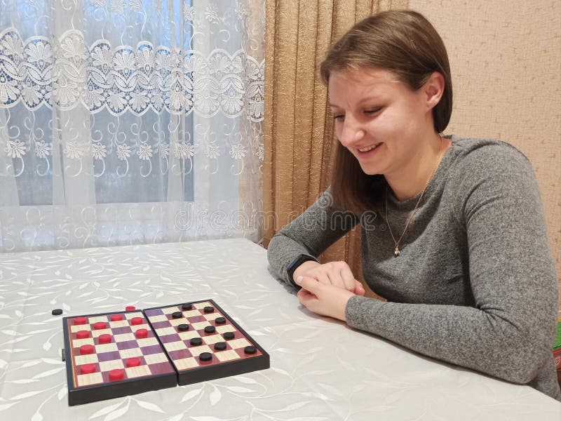 Smiling Girl Play Checkers at Table Stock Photo - Image of skill ...