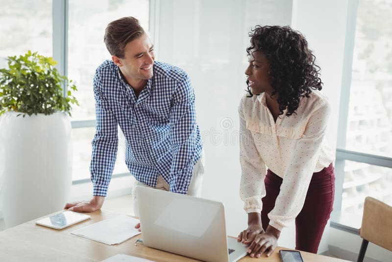 Smiling Executives Interacting with Each Other at Desk Stock Image ...