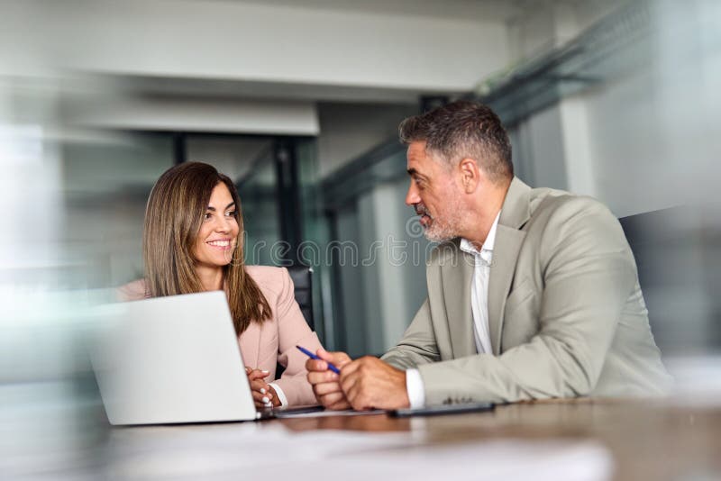 2 Smiling Executives Using Laptop Discussing Work at Office Meeting ...