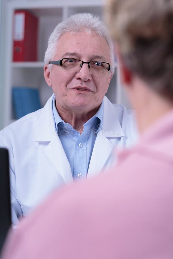 Smiling experienced doctor stock image. Image of male - 53725153