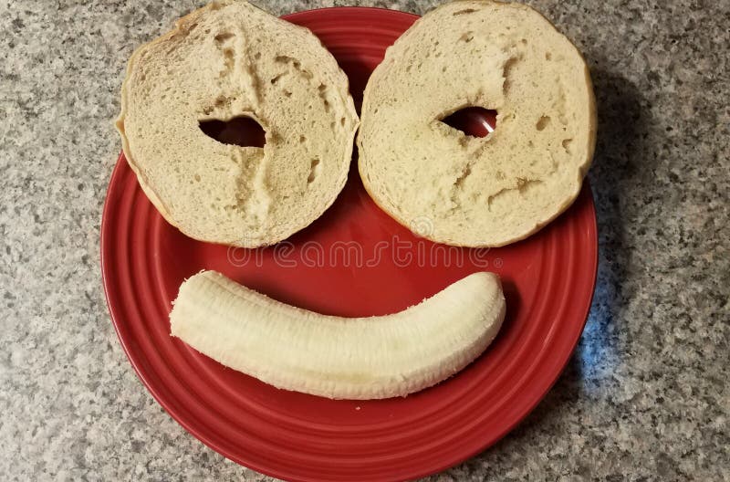 Smiling Face with Bagels and Banana on Plate Stock Photo - Image of ...