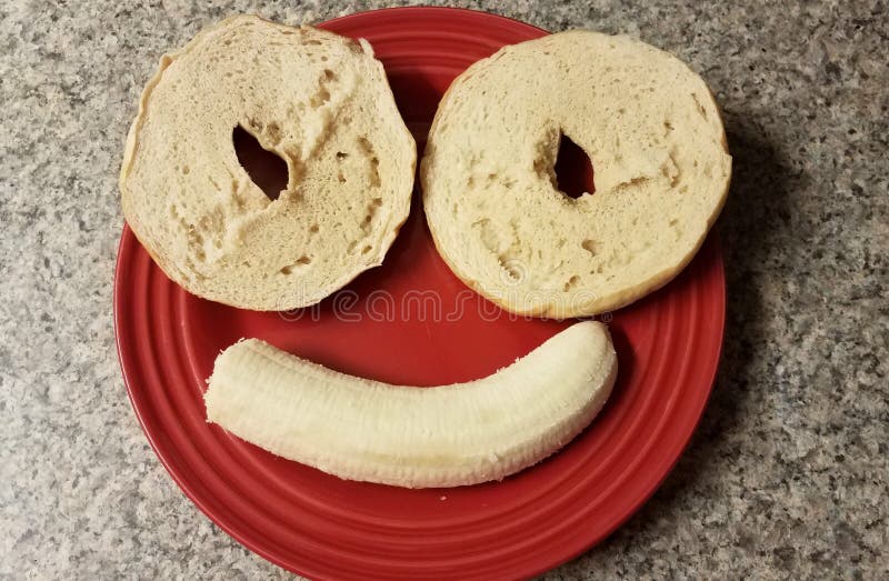 Smiling Face with Bagels and Banana on Plate Stock Photo - Image of ...