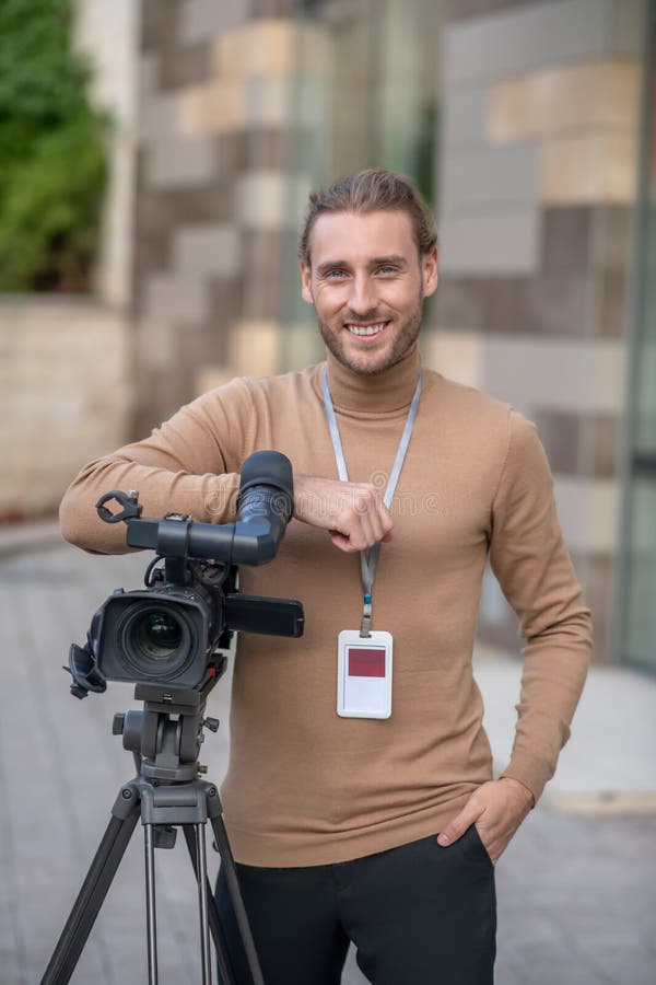 A Cameraman Standing with Thumbs Up Next To His Shooting Equipment ...