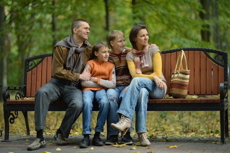 Smiling Family in Autumn Forest Sitting on Bench Stock Image - Image of ...