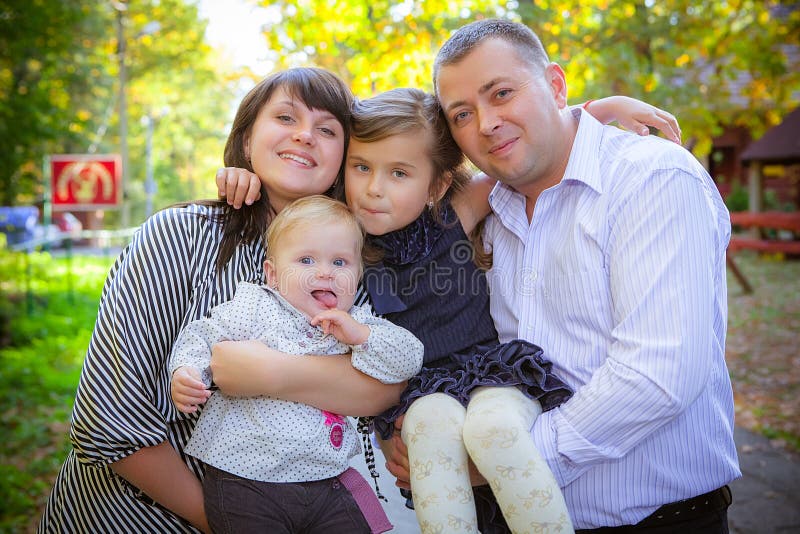 Smiling Family with Children Outdoors Stock Photo - Image of looking ...